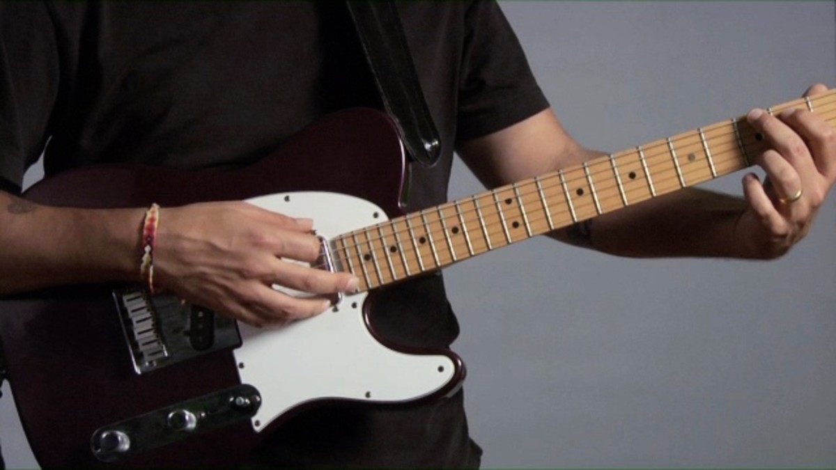 How To Hold A Guitar While Standing Howcast
