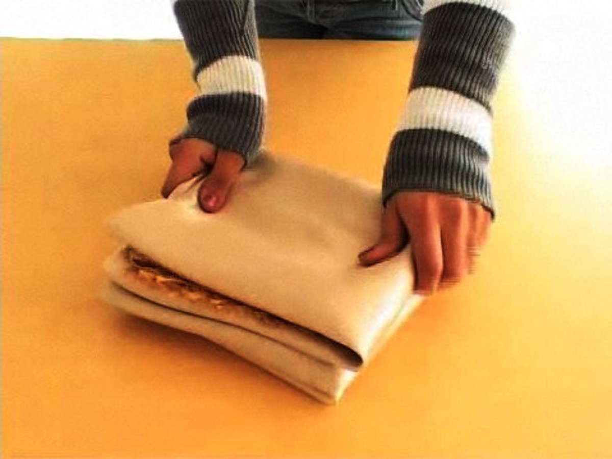 How To Fold A Round Tablecloth Howcast how-to-fold-a-round-tablecloth-howcast